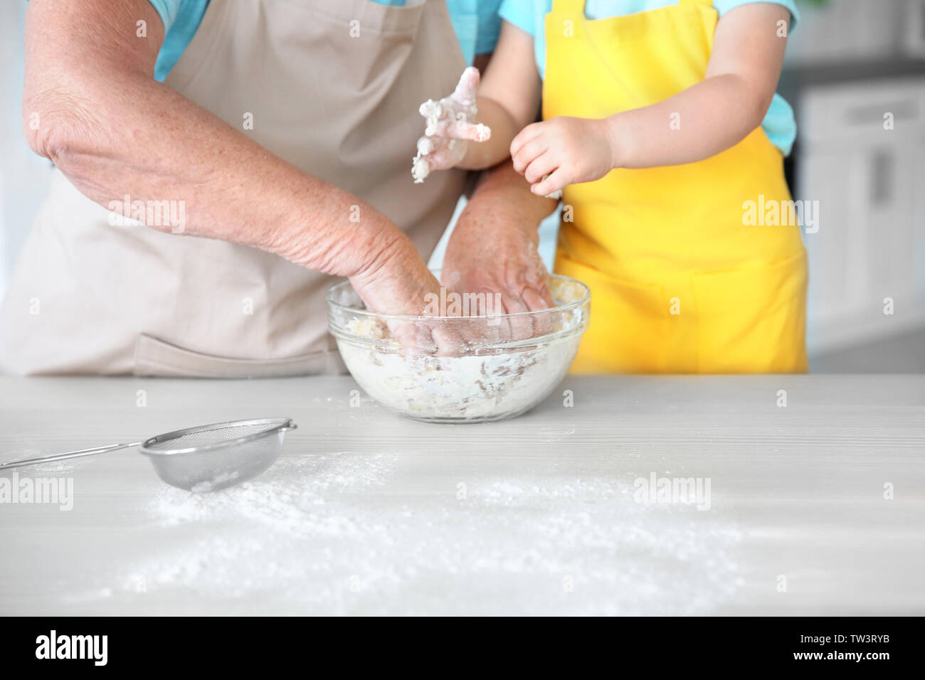Little girl and her grandmother cooking on kitchen Stock Photo - Alamy
