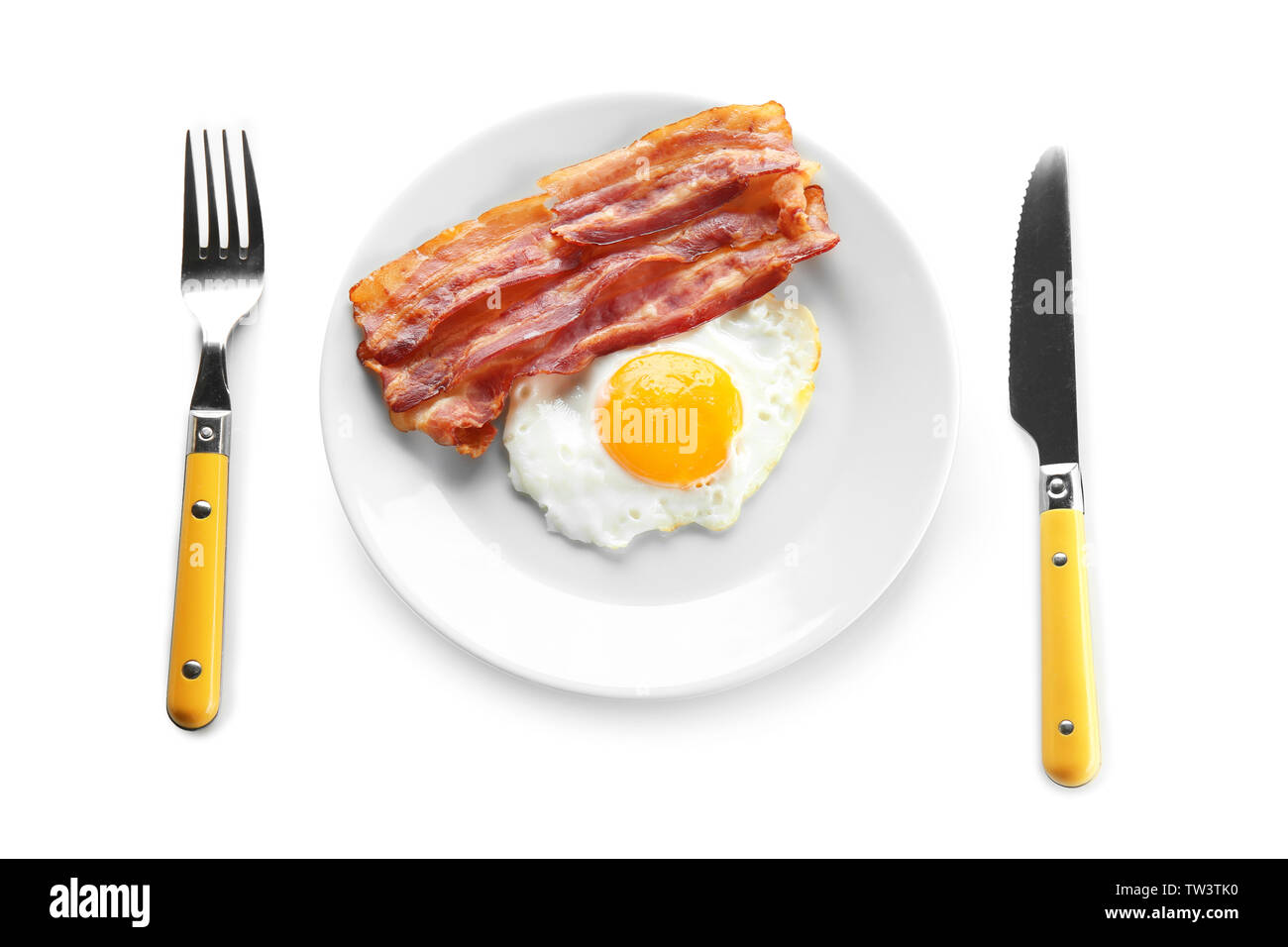 Plate with fried egg, bacon and cutlery on white background Stock Photo ...