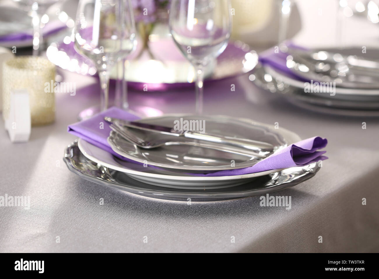 Beautiful table setting with lilac napkin and silver cutlery Stock ...