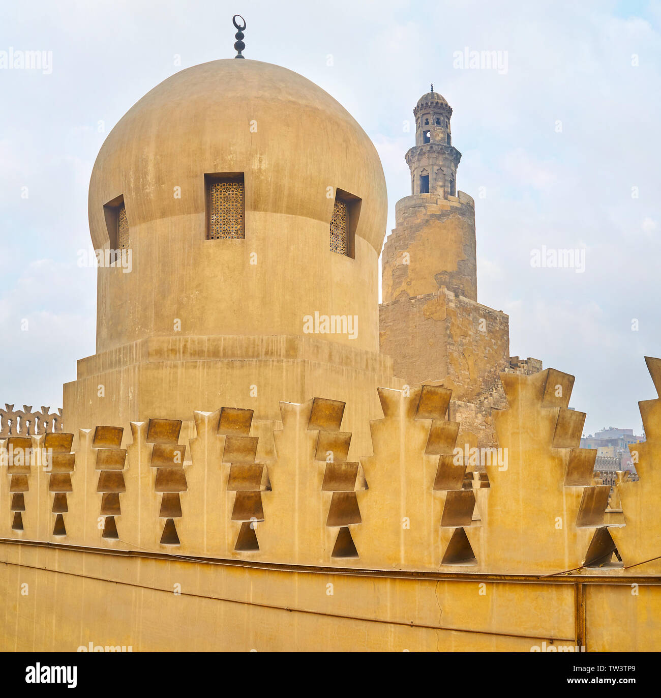 The view through the decorative battlements on the modest dome of Amir ...