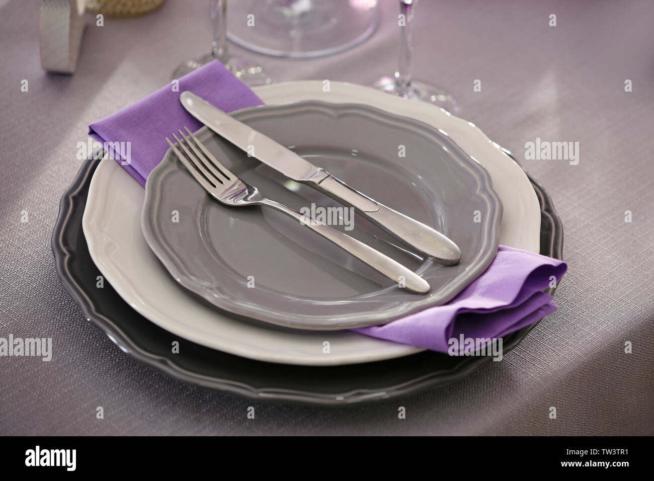 Beautiful table setting with lilac napkin and silver cutlery Stock ...