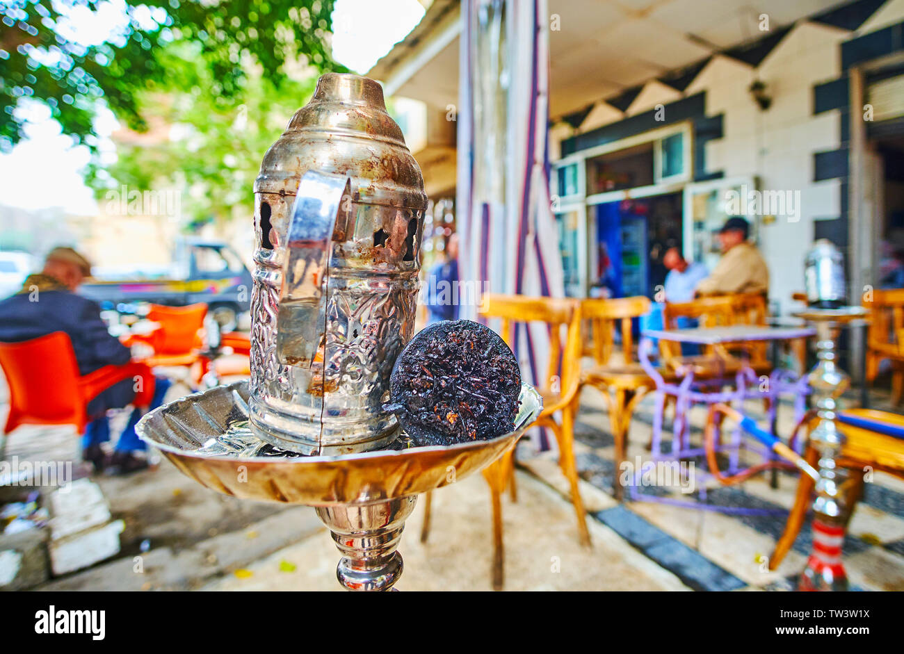 The close-up of charcoal tray and bowl of hookah (shisha) with a view ...