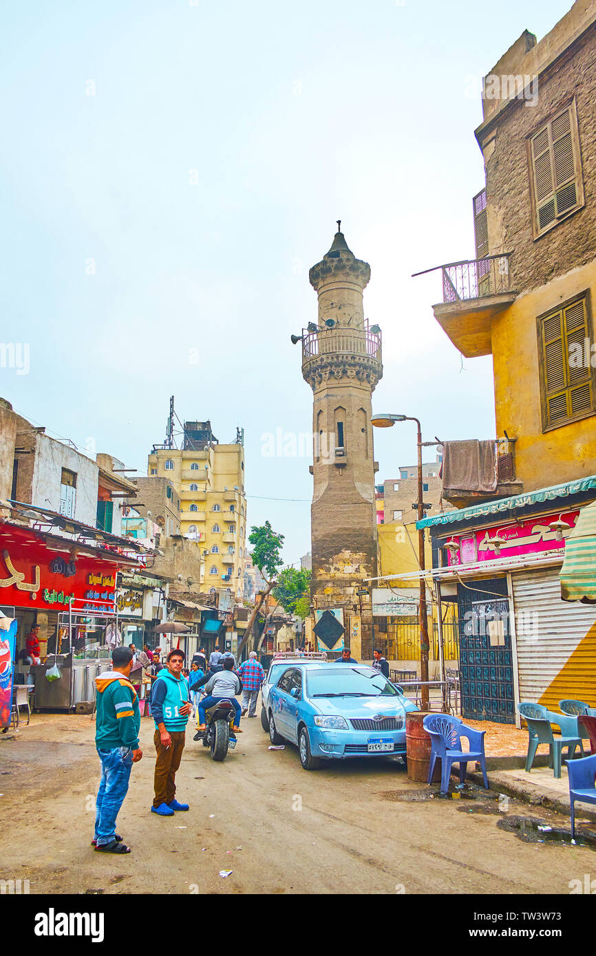 CAIRO, EGYPT - DECEMBER 22, 2017: The old small minaret amid the stalls ...
