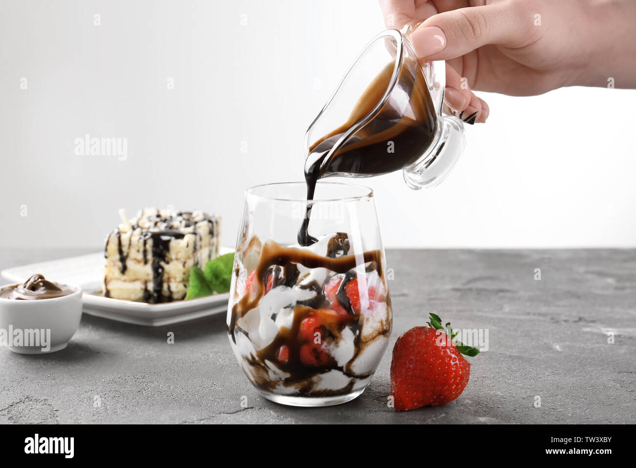 Woman pouring sauce onto piece hi-res stock photography and images - Alamy