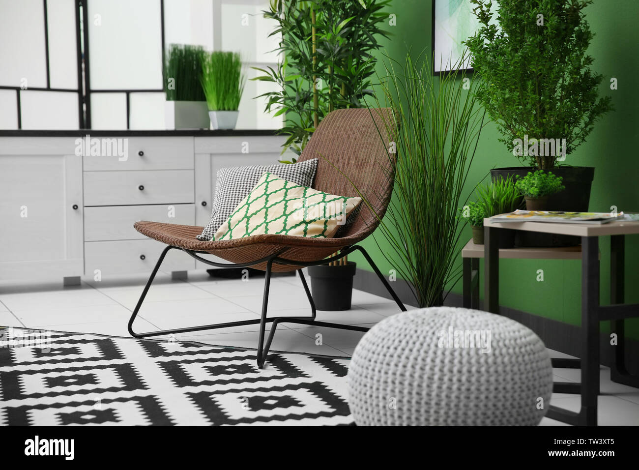 Cozy armchair in modern green interior Stock Photo - Alamy