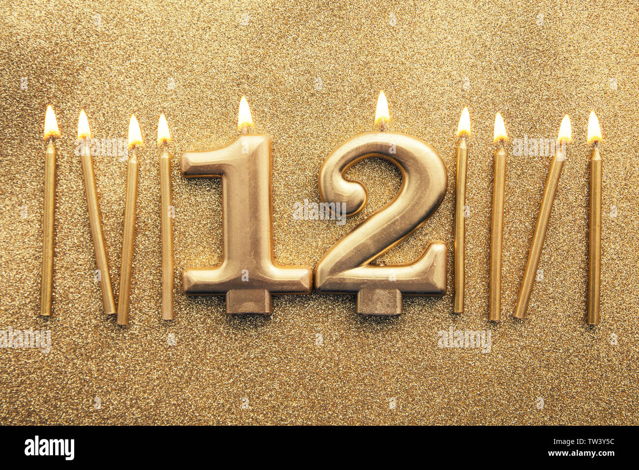 Number 12 gold celebration candle on a glitter background Stock Photo ...