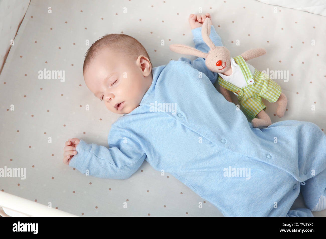 Cute little baby with toy sleeping in cradle at home Stock Photo - Alamy