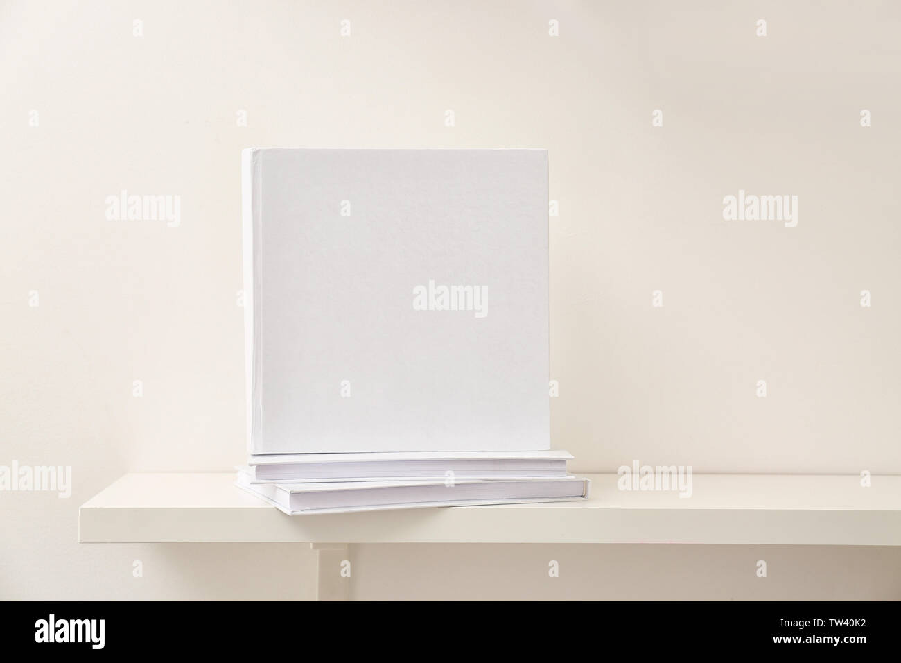 Books with blank white covers on shelf Stock Photo - Alamy