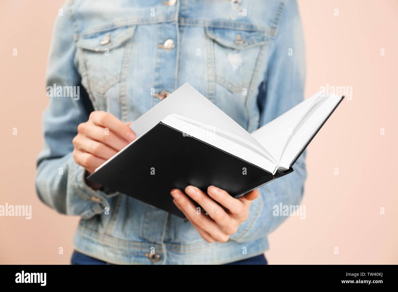 Woman showing open book hi-res stock photography and images - Alamy