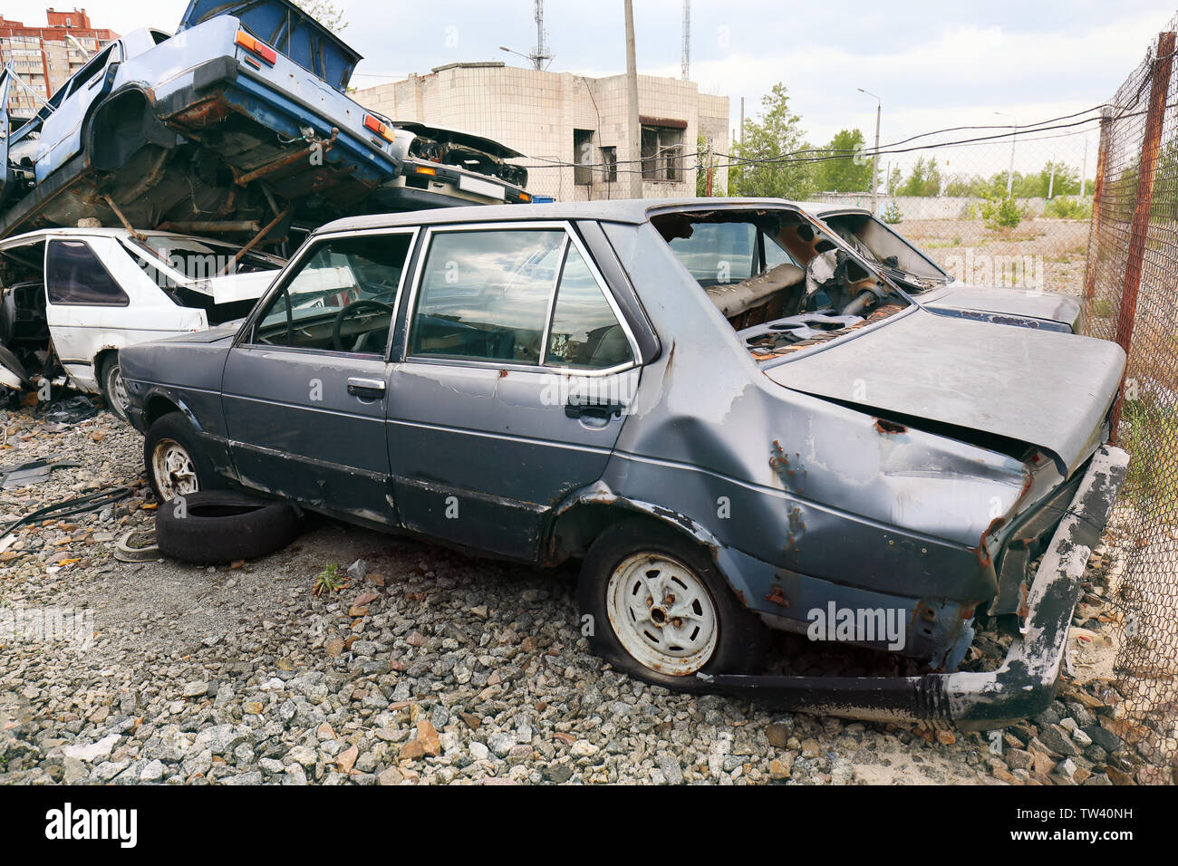 Piled crushed cars on salvage yard Stock Photo - Alamy