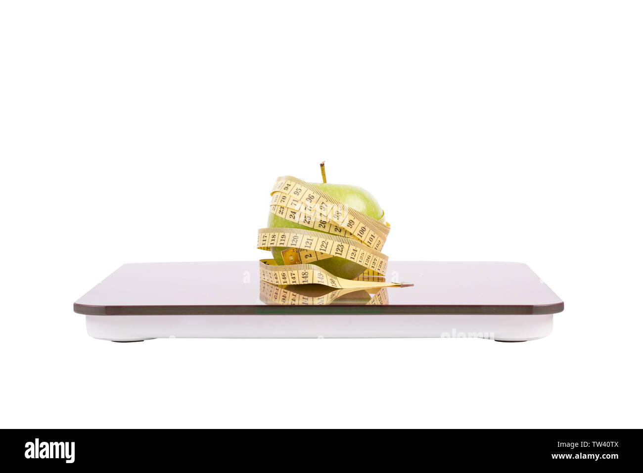 An apple and a ruler on the electronic scale Stock Photo - Alamy