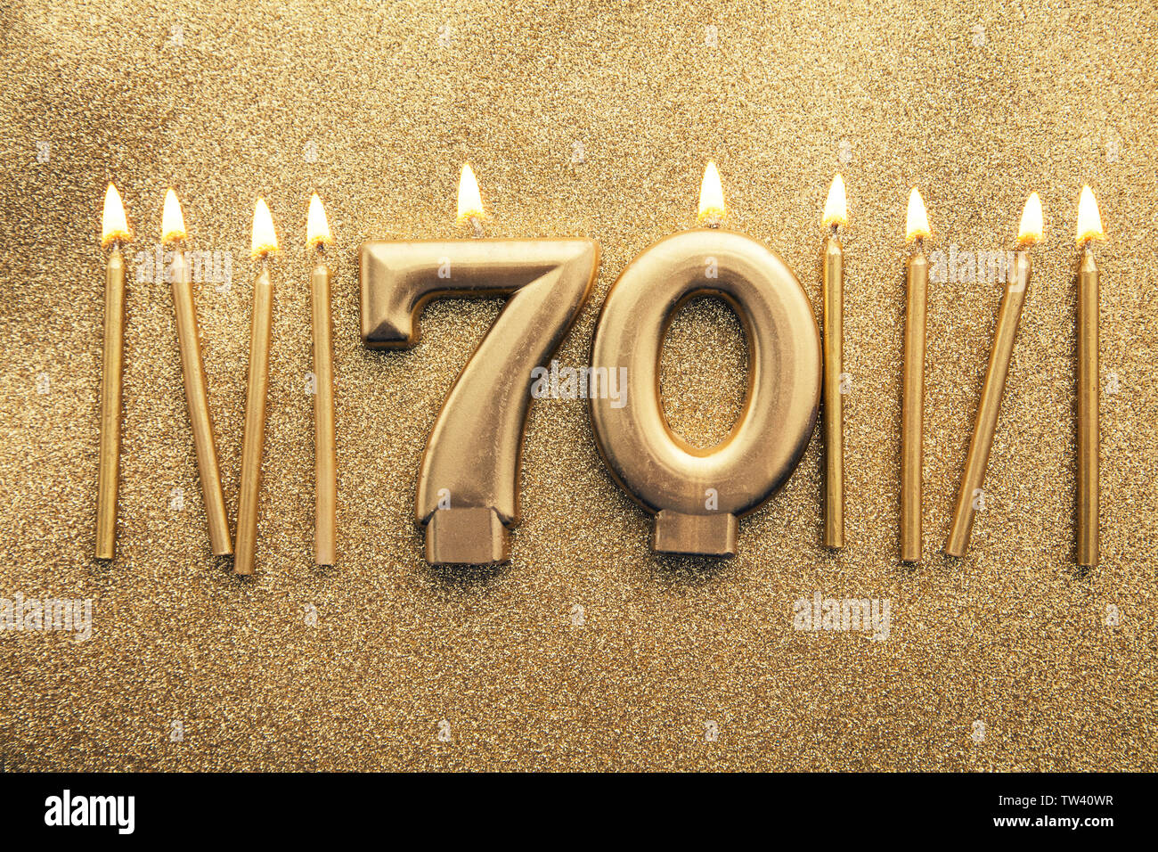 Number 70 gold celebration candle on a glitter background Stock Photo ...