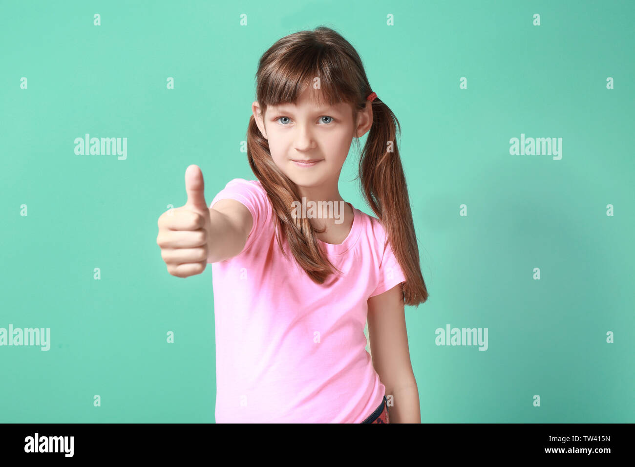 Pretty little girl on color background Stock Photo - Alamy
