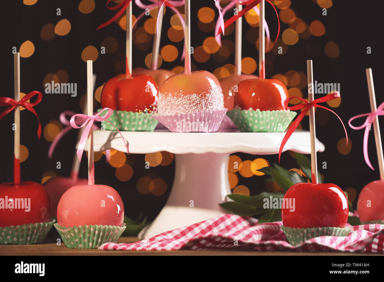 Ceramic stand with delicious candy apples on blurred background Stock ...