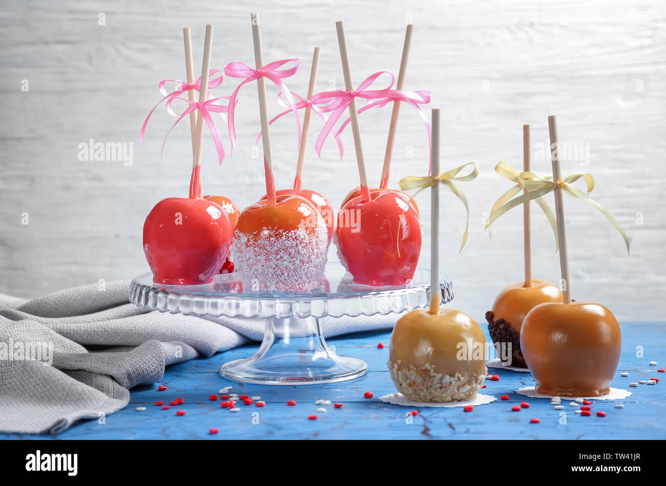 Glass stand with delicious candy apples on table Stock Photo - Alamy