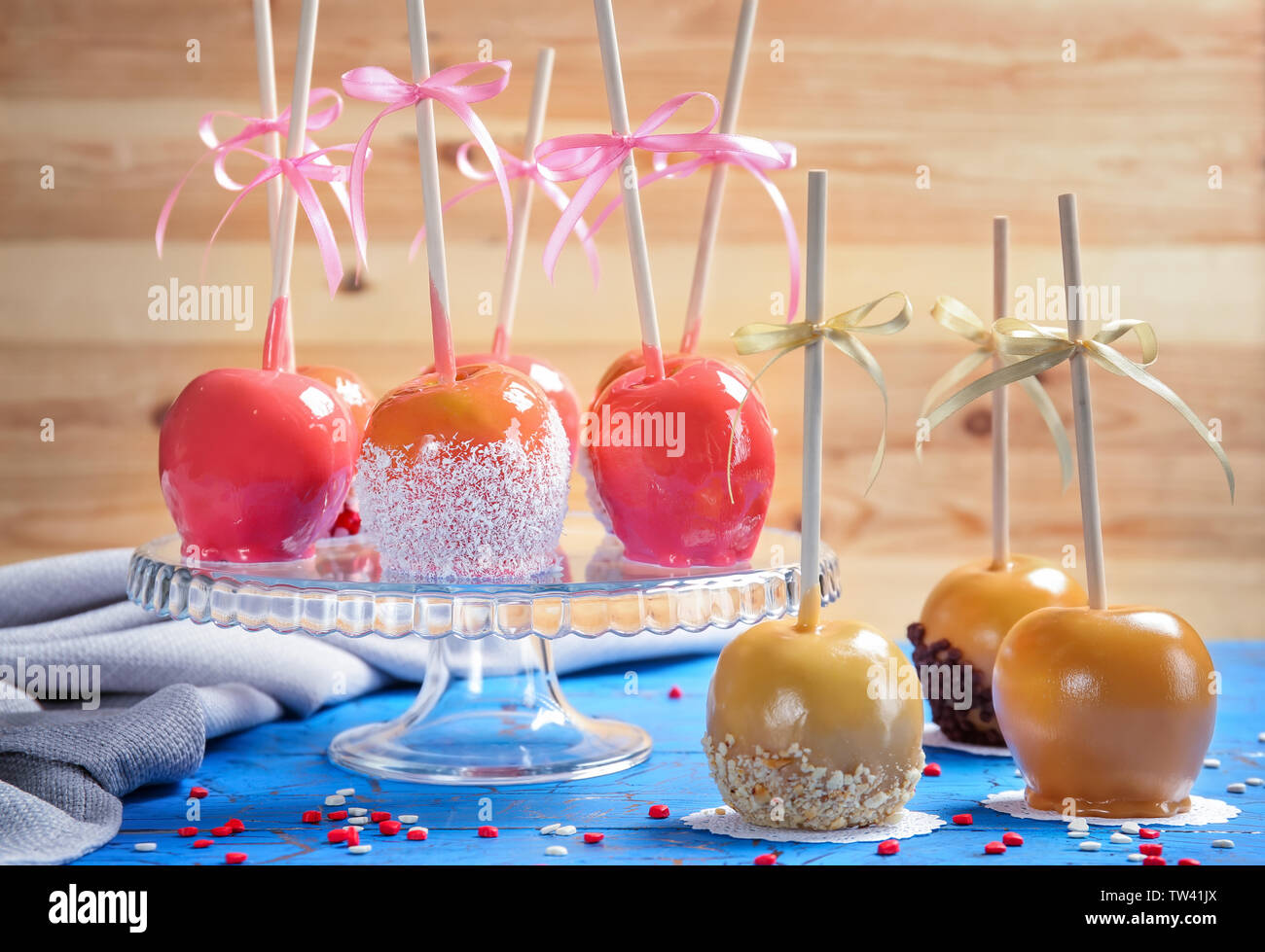Glass stand with delicious candy apples on table Stock Photo - Alamy