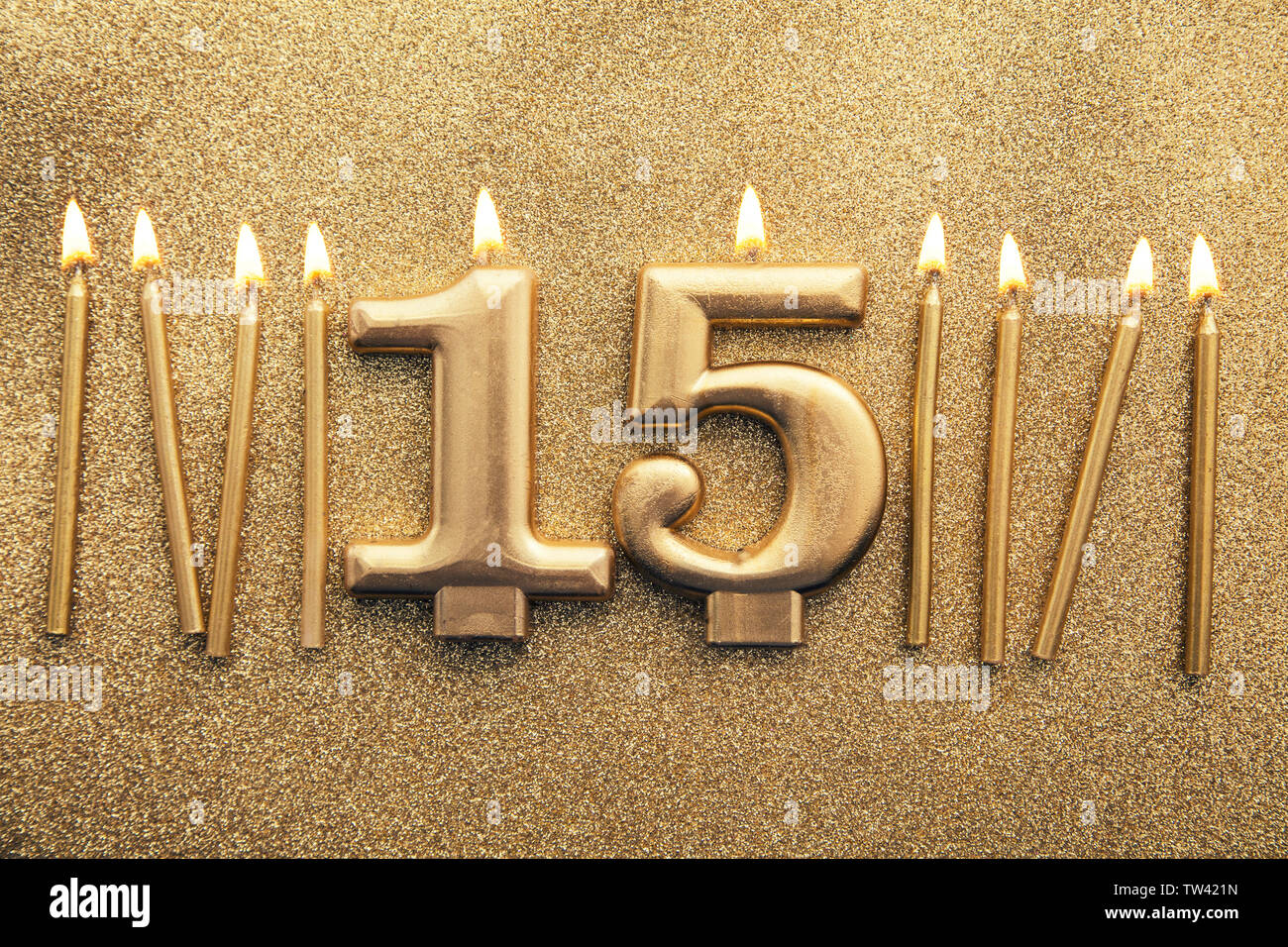 Number 15 gold celebration candle on a glitter background Stock Photo ...
