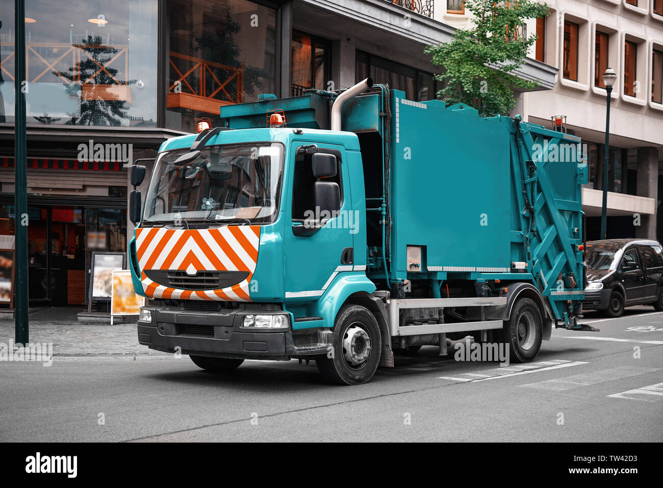Garbage truck on city street. Ecology concept Stock Photo - Alamy