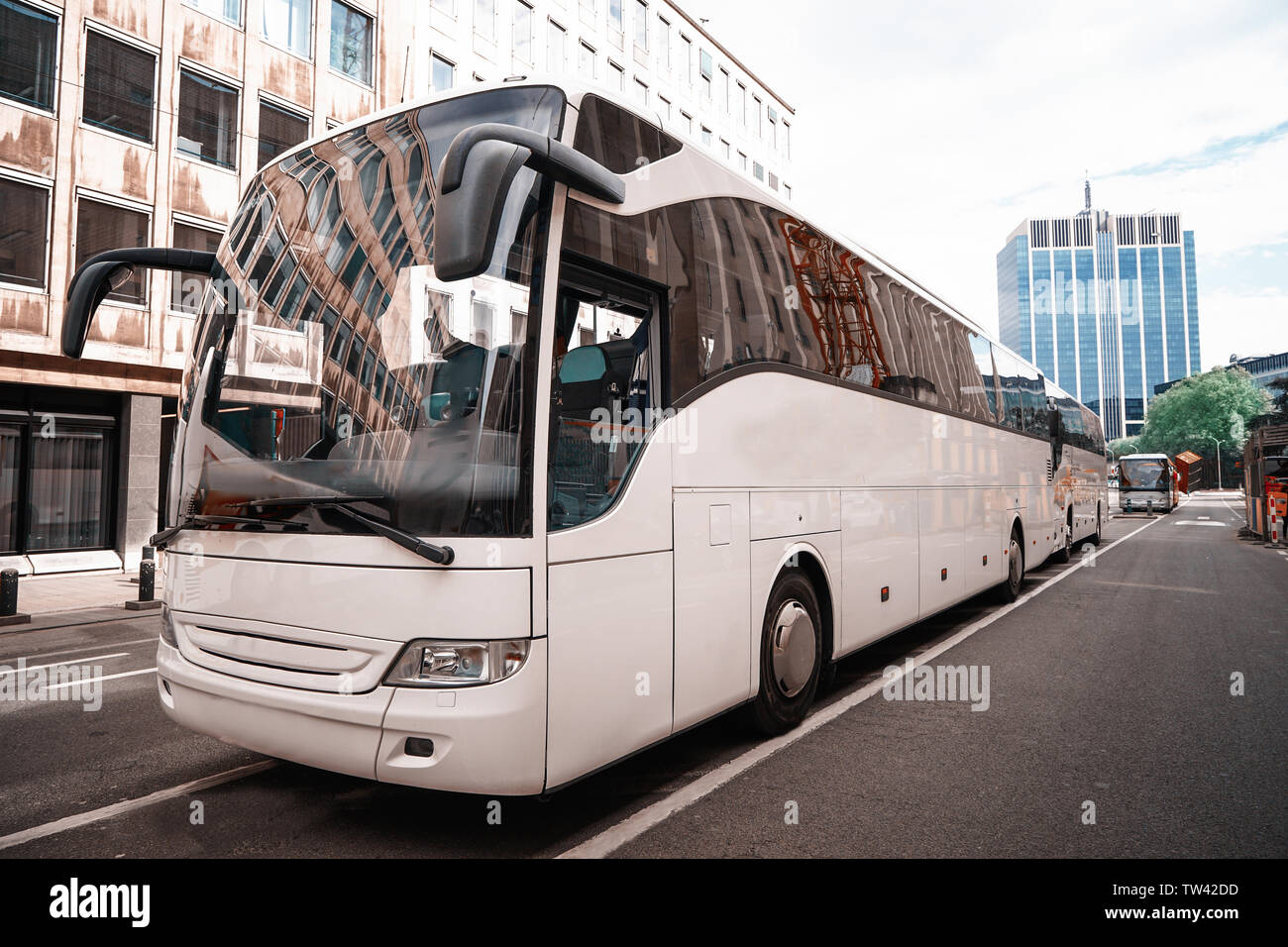 New modern bus parked in beautiful city Stock Photo - Alamy