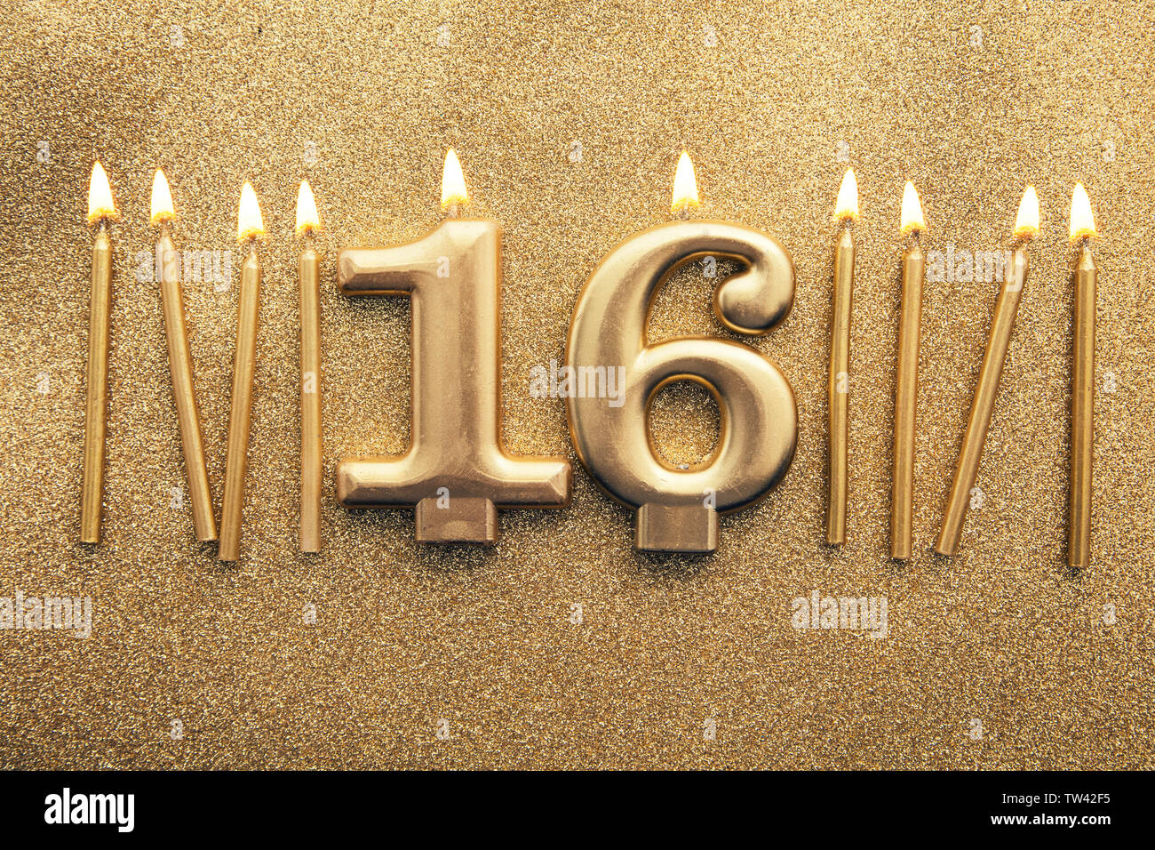 Number 16 gold celebration candle on a glitter background Stock Photo ...