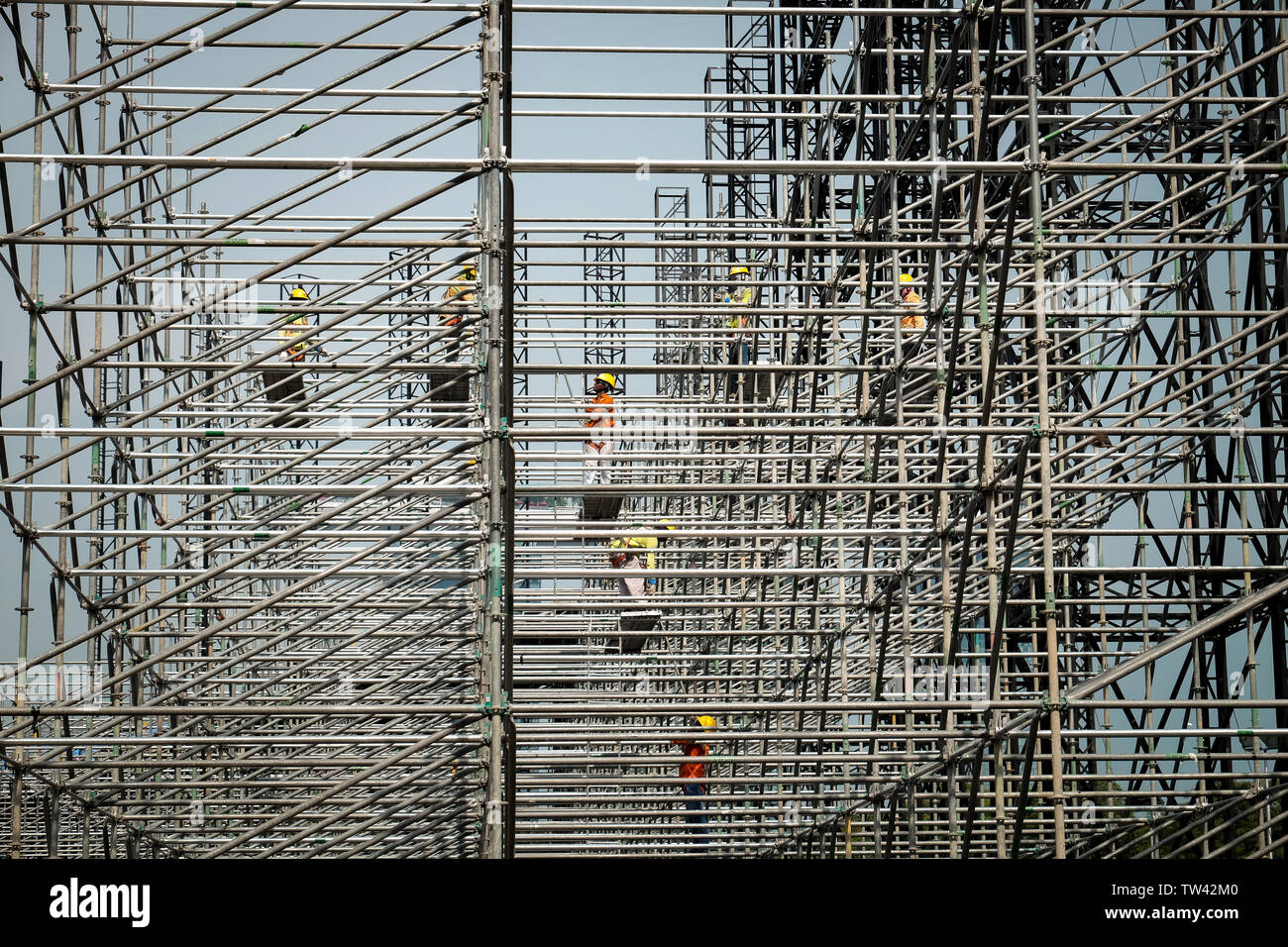 Workers putting up a temporary scaffolding seating structure for an ...