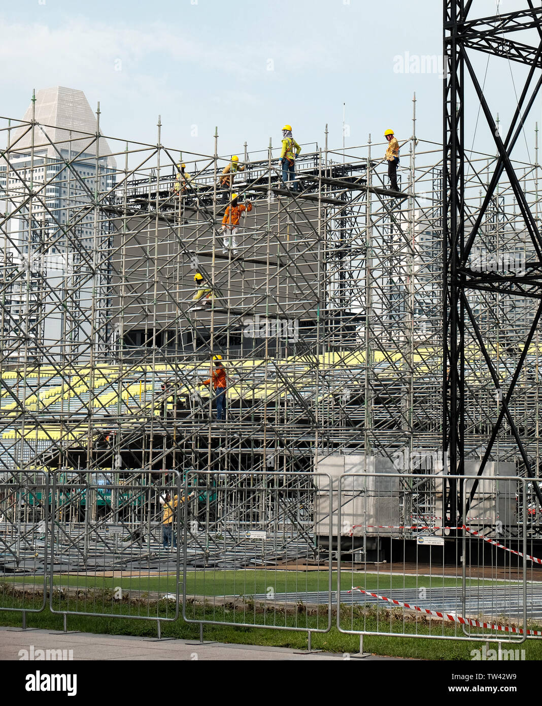 Workers putting up a temporary scaffolding seating structure for an ...