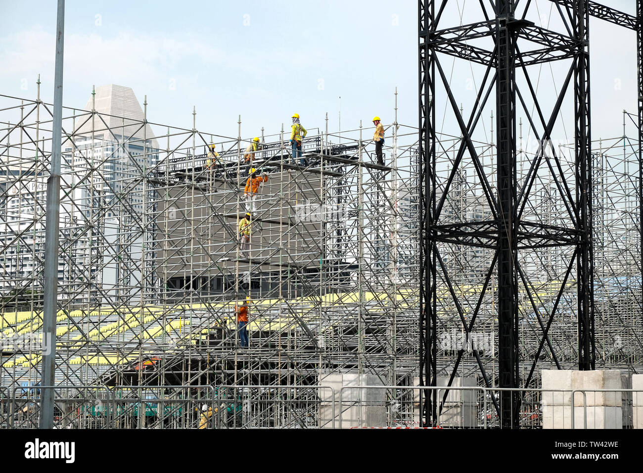Workers putting up a temporary scaffolding seating structure for an ...