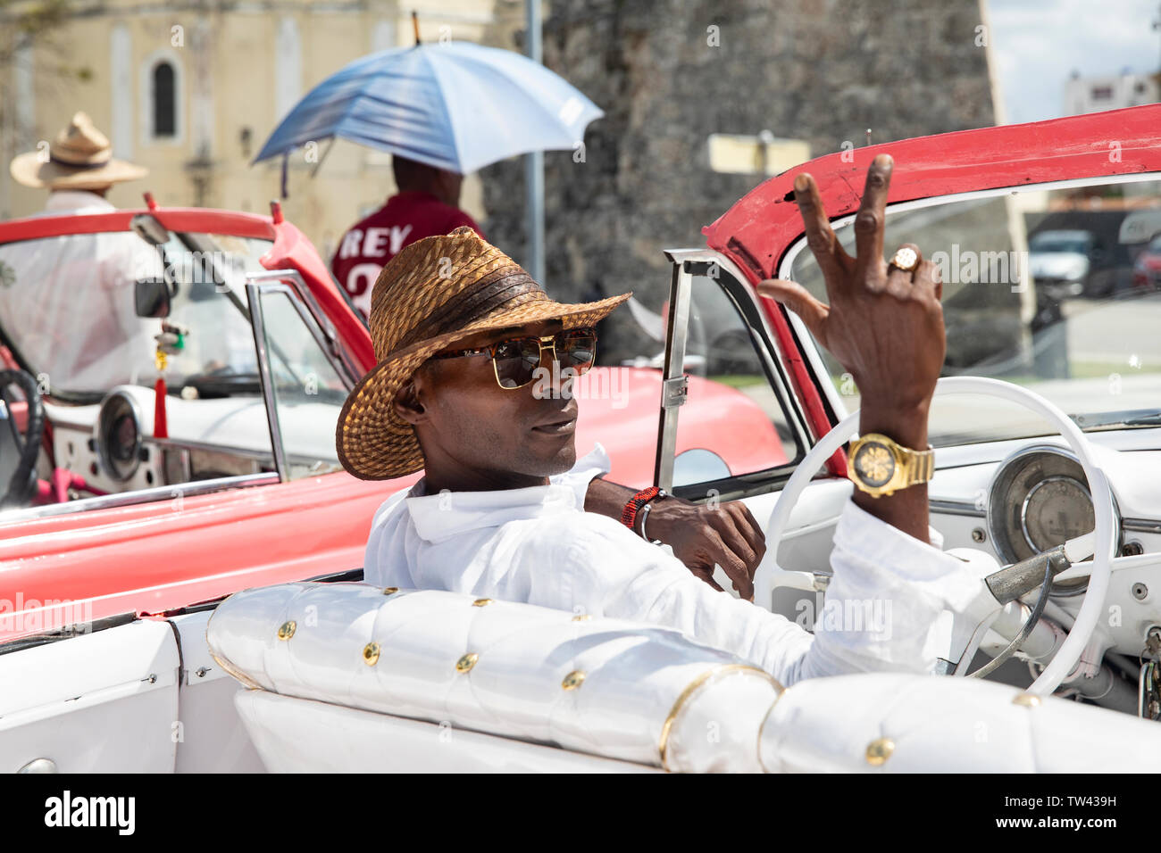 A Cuban taxi driver driving an old American car in Havana giving me the ...
