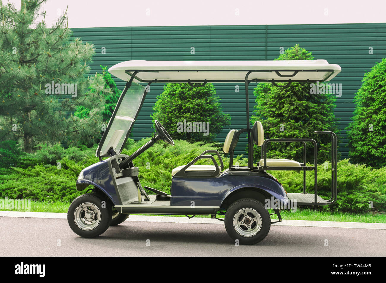 Modern cart on road in golf club Stock Photo - Alamy