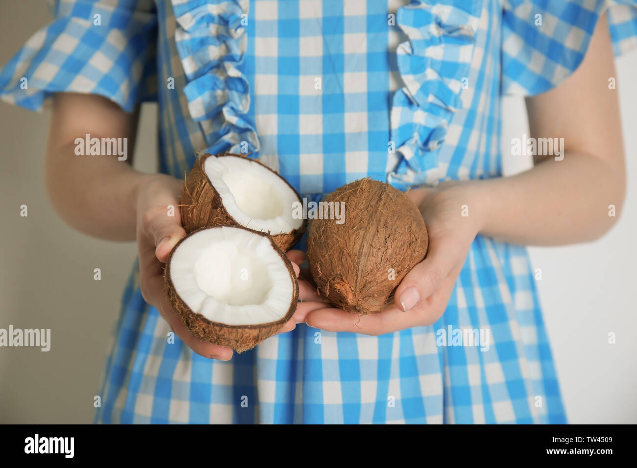 Young woman with coconuts on white background Stock Photo - Alamy