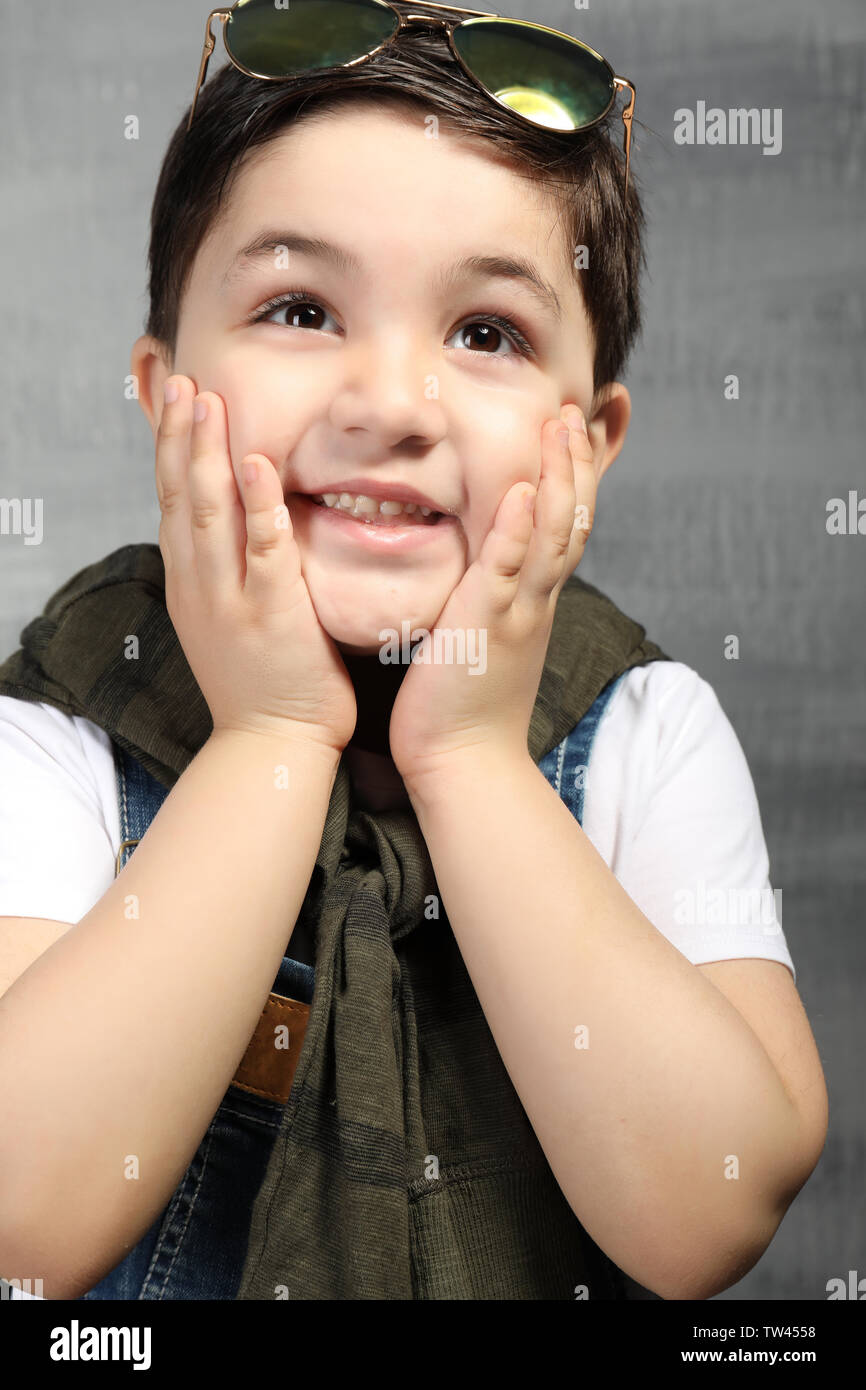 Funny little boy on grey background Stock Photo - Alamy