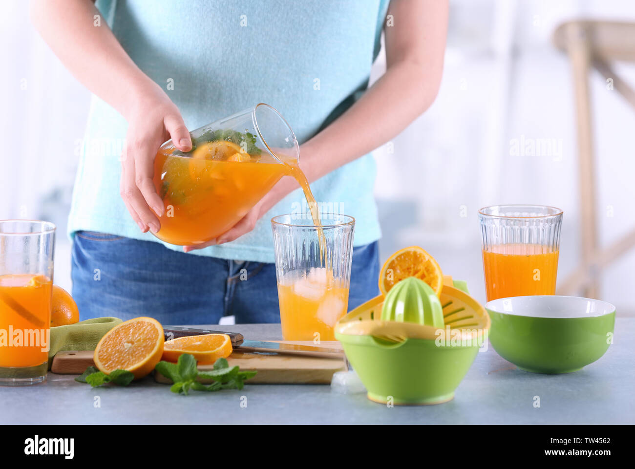 Woman pouring orange lemonade hi-res stock photography and images - Alamy