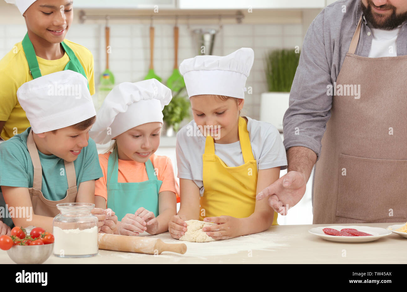 Group of children and teacher in kitchen during cooking classes Stock ...