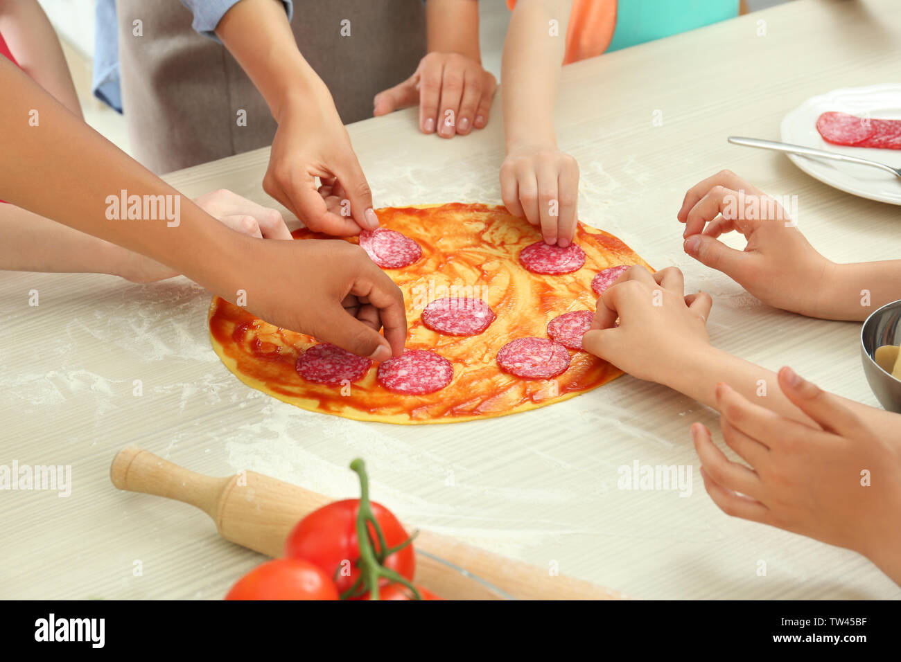 Group of children preparing pizza during cooking classes Stock Photo ...