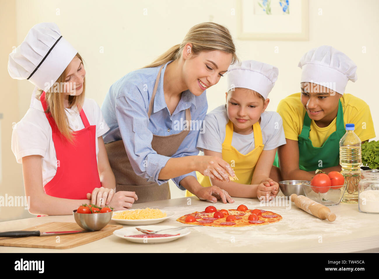 Group of children and teacher in kitchen during cooking classes Stock ...