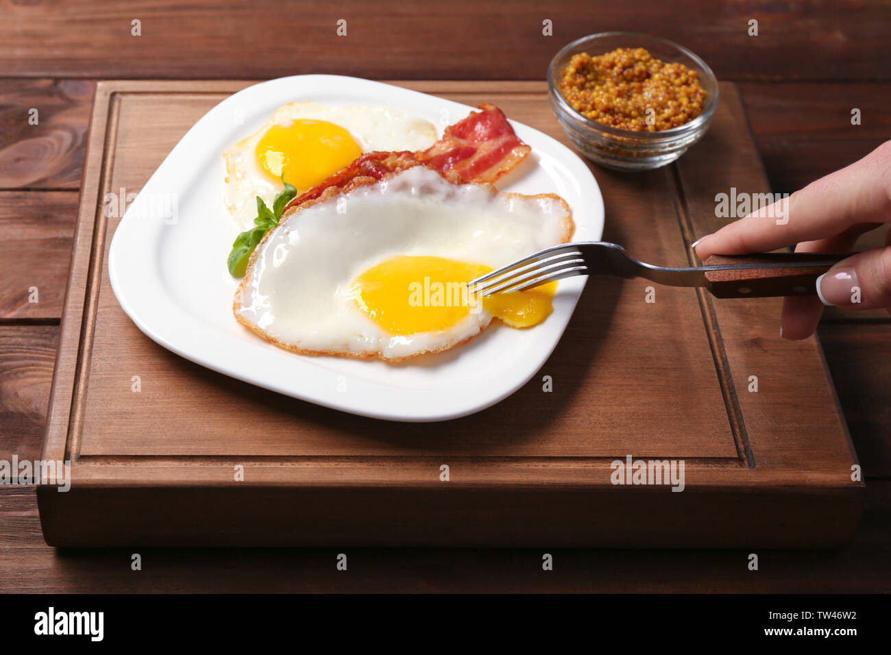 Woman bacon eggs table hi-res stock photography and images - Alamy
