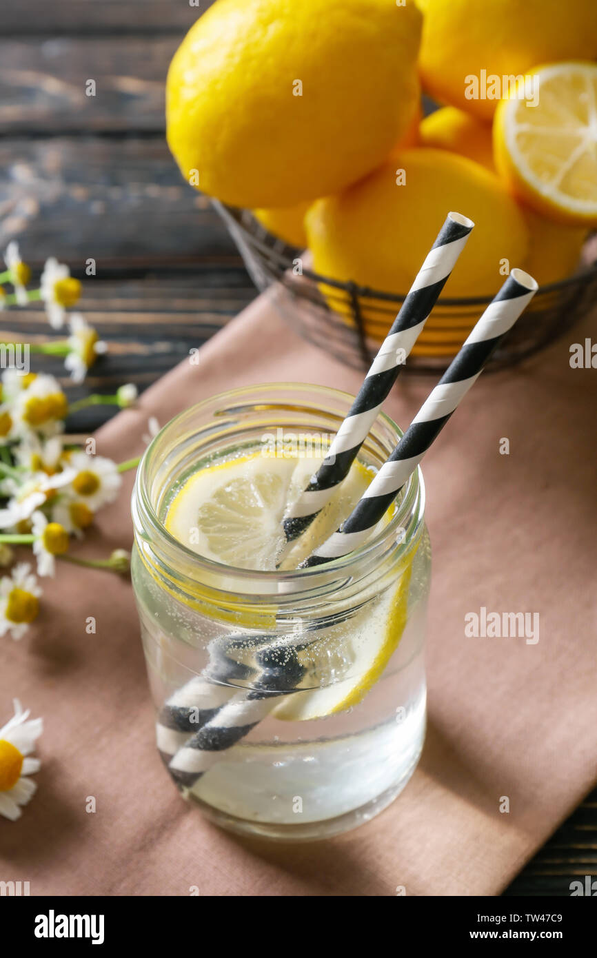 Glass jar with cold lemon water on table Stock Photo - Alamy