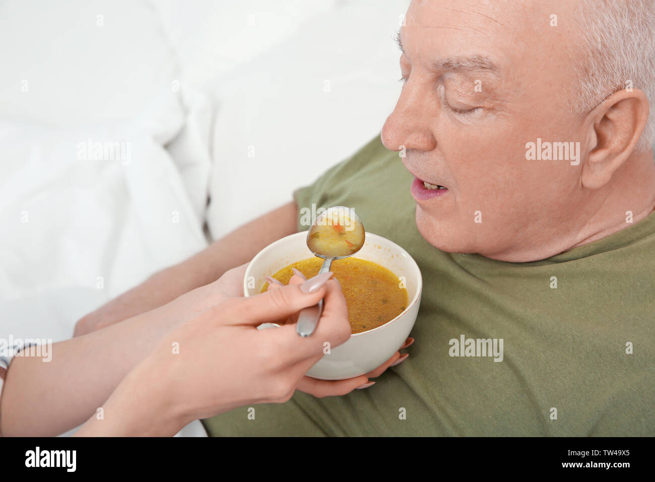 Spoon feeding elderly hi-res stock photography and images - Alamy