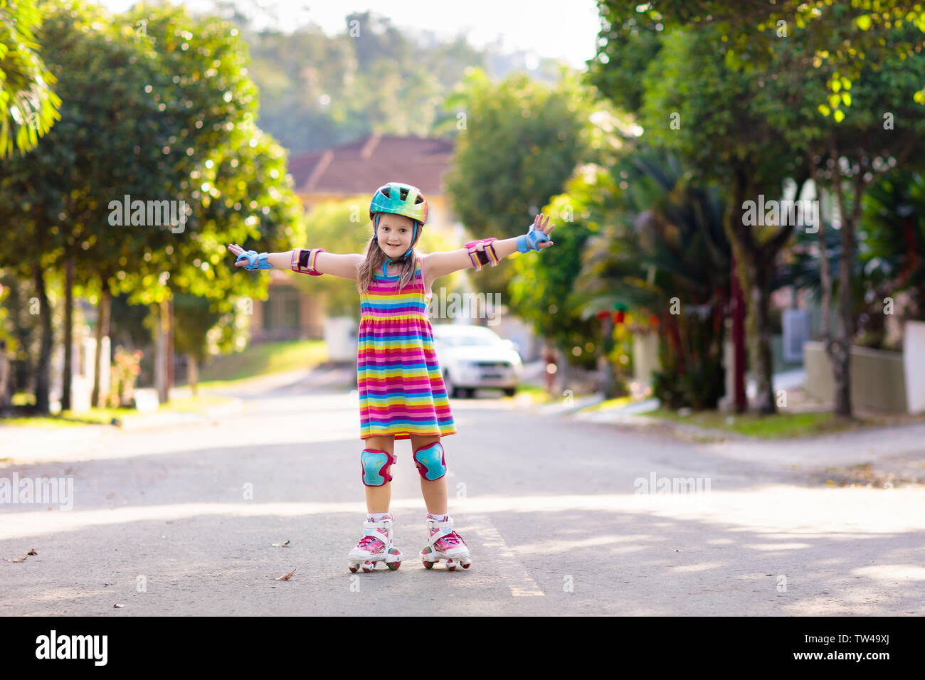 Child on inline skates in park. Kids learn to skate roller blades ...