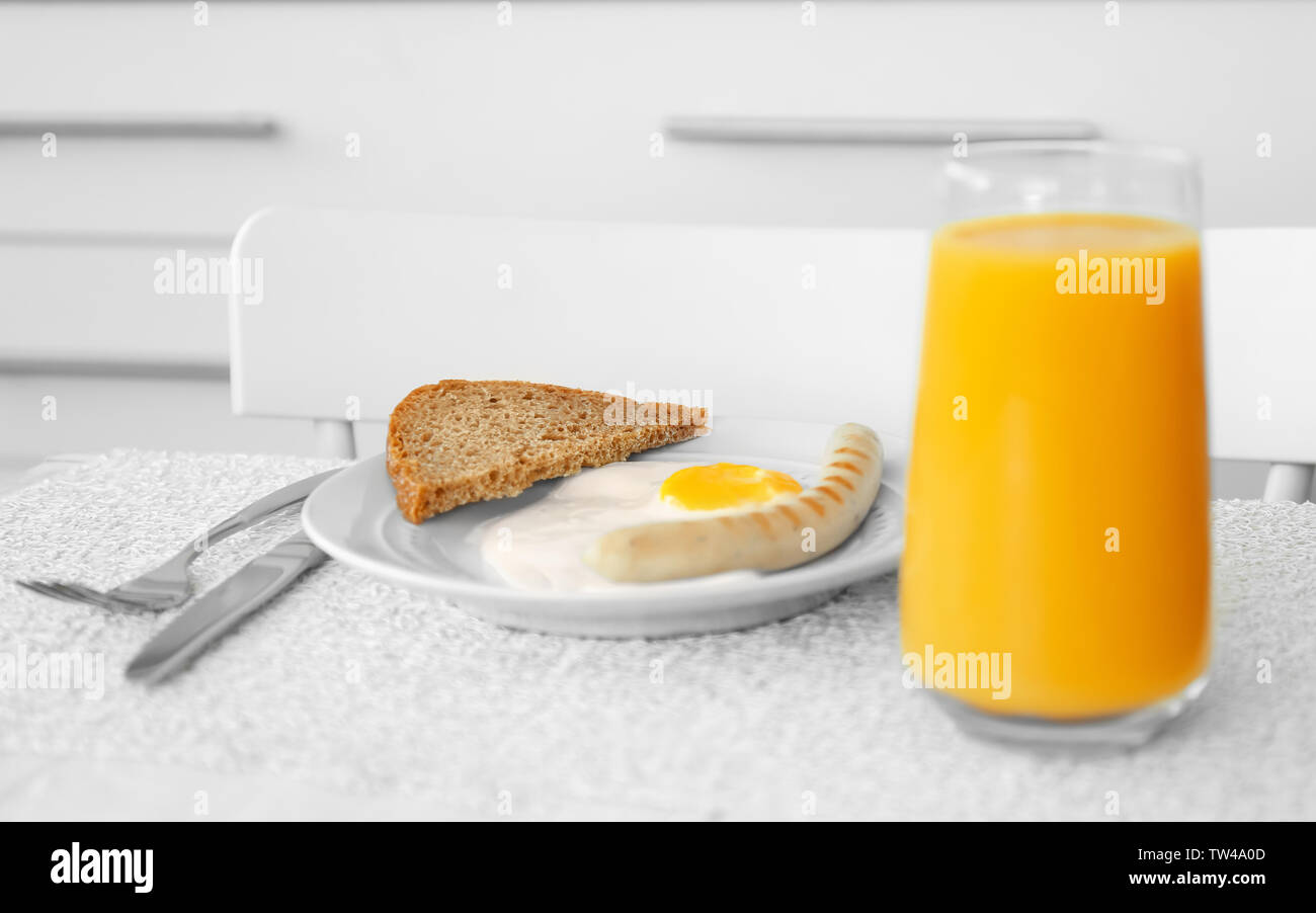Delicious breakfast with over easy egg on kitchen table Stock Photo - Alamy