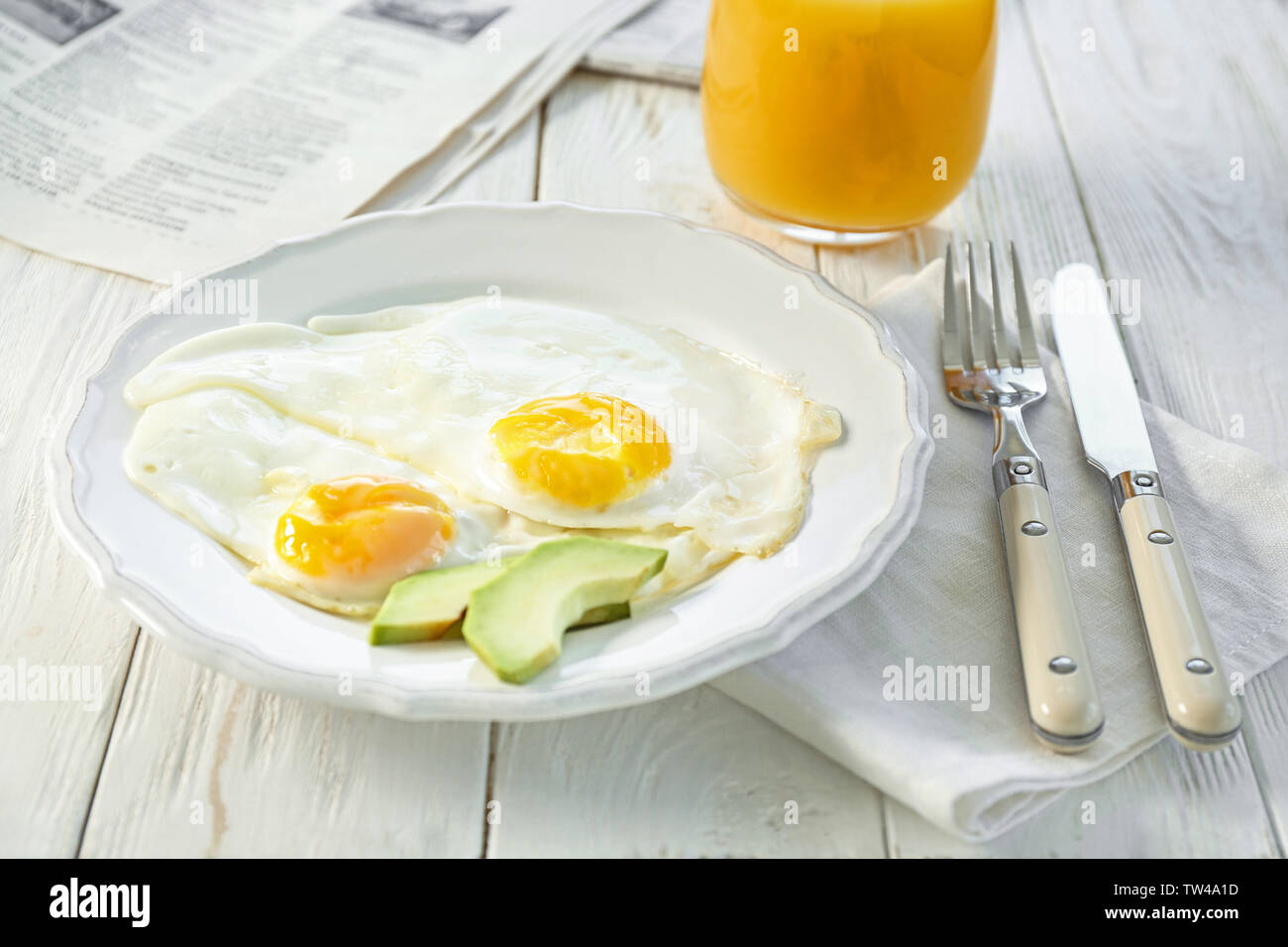 Delicious breakfast with over easy eggs on kitchen table Stock Photo ...