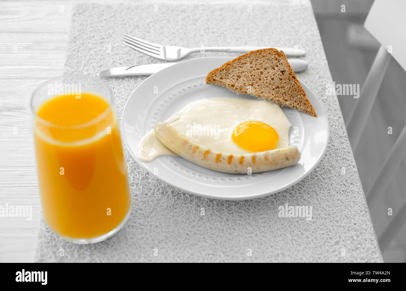 Delicious breakfast with over easy egg on kitchen table Stock Photo - Alamy