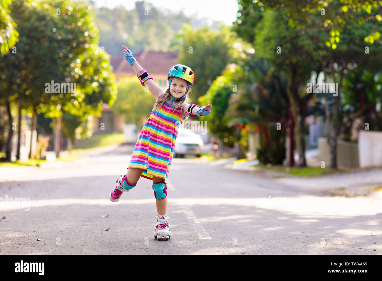 Child on inline skates in park. Kids learn to skate roller blades ...