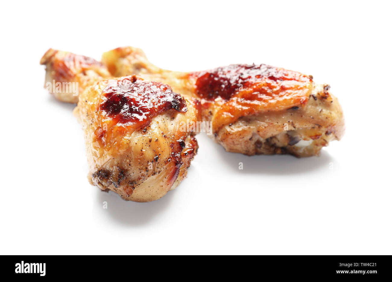 Roasted chicken legs on white background Stock Photo - Alamy