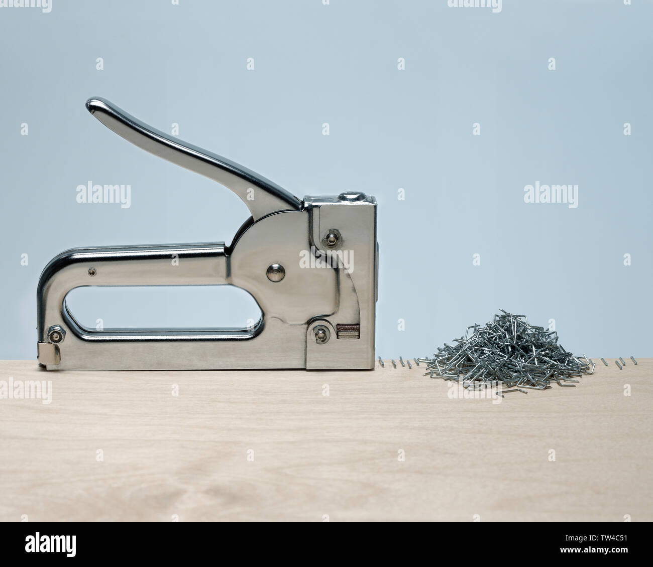 Silver metal stapler malfunctions creating precise row and random pile ...