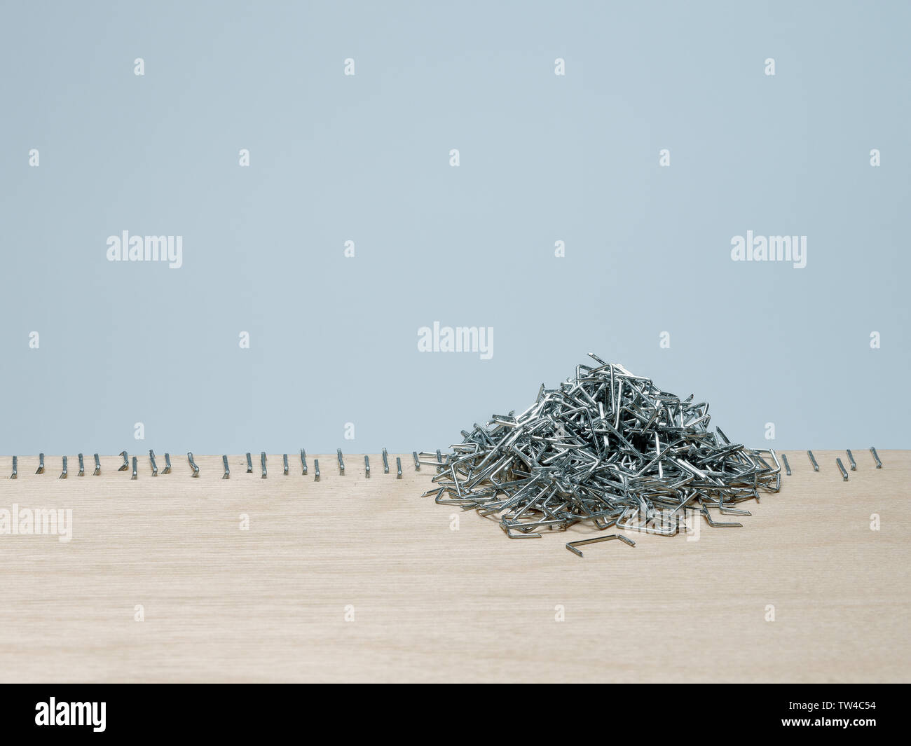 Silver metal stapler malfunctions creating precise row and random pile ...