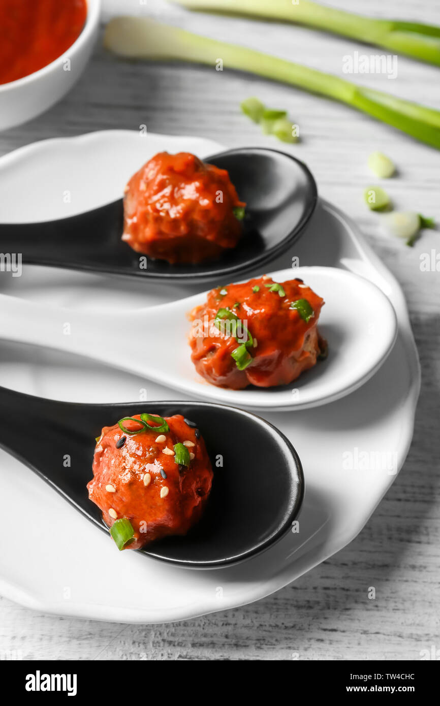 Spoons with delicious meatballs on plate Stock Photo - Alamy