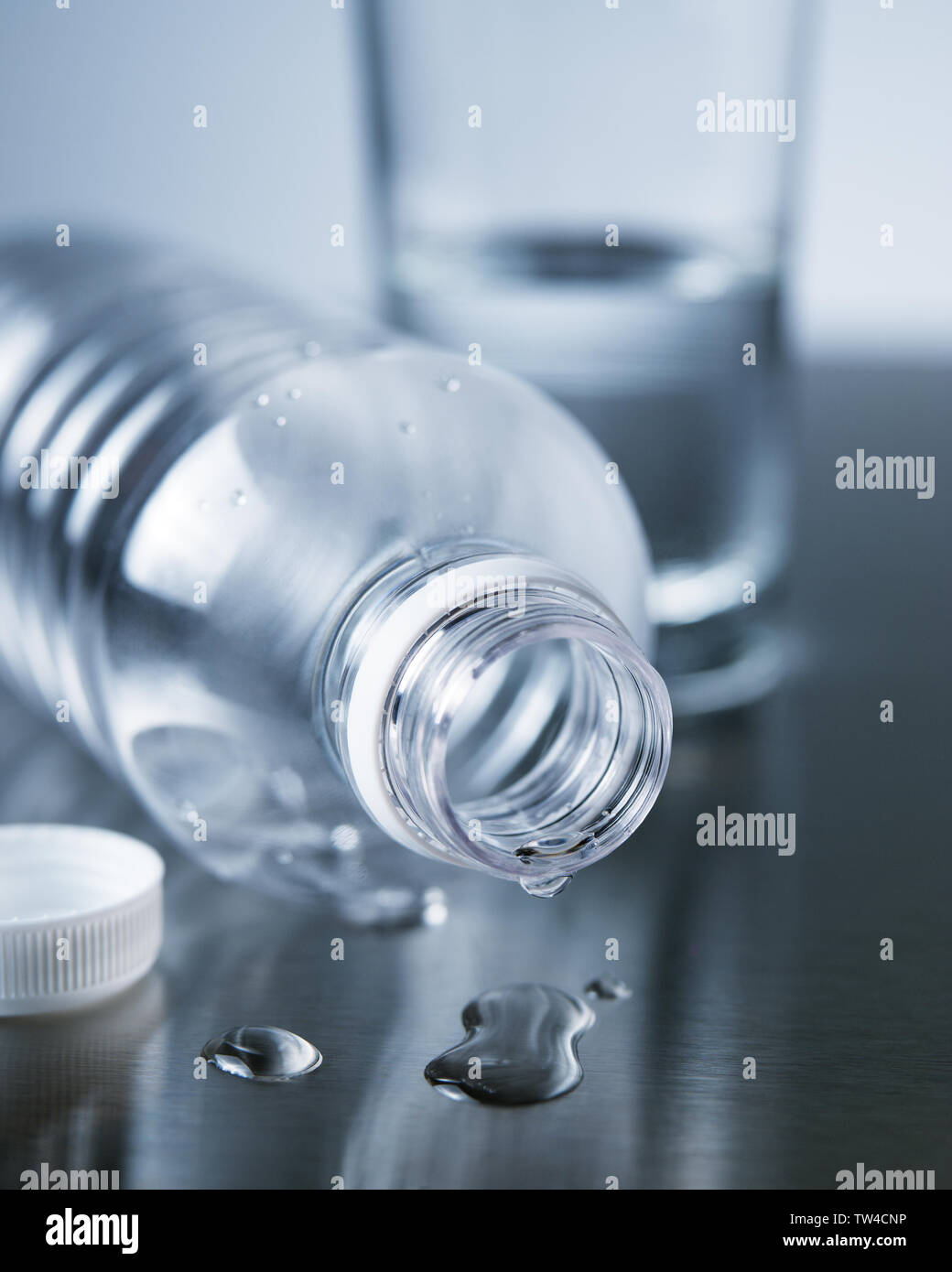 Selective focus image of empty plastic water bottle, water drips and ...