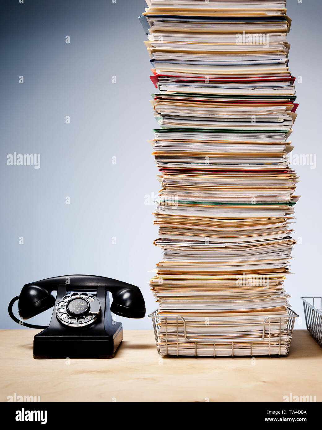 Old telephone on desk with tall pile of files and paperwork Stock Photo ...
