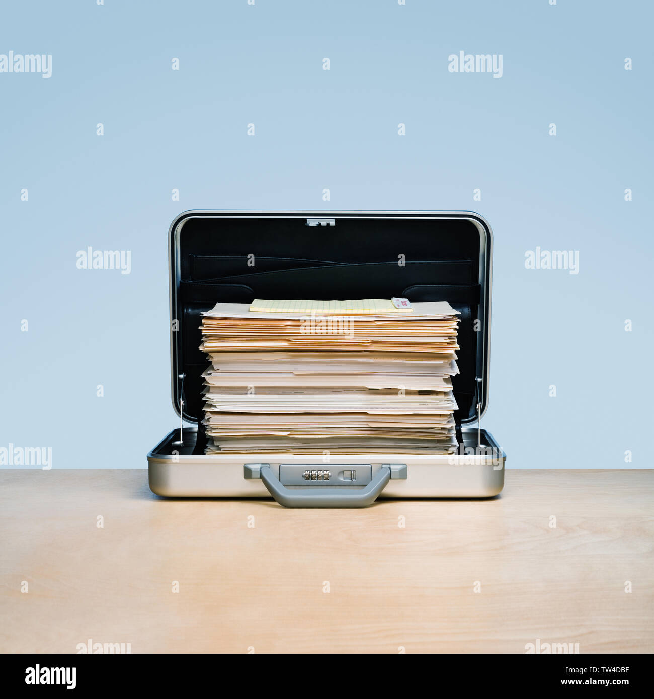 Overtime, tall stack of files and folders in aluminum briefcase. on ...